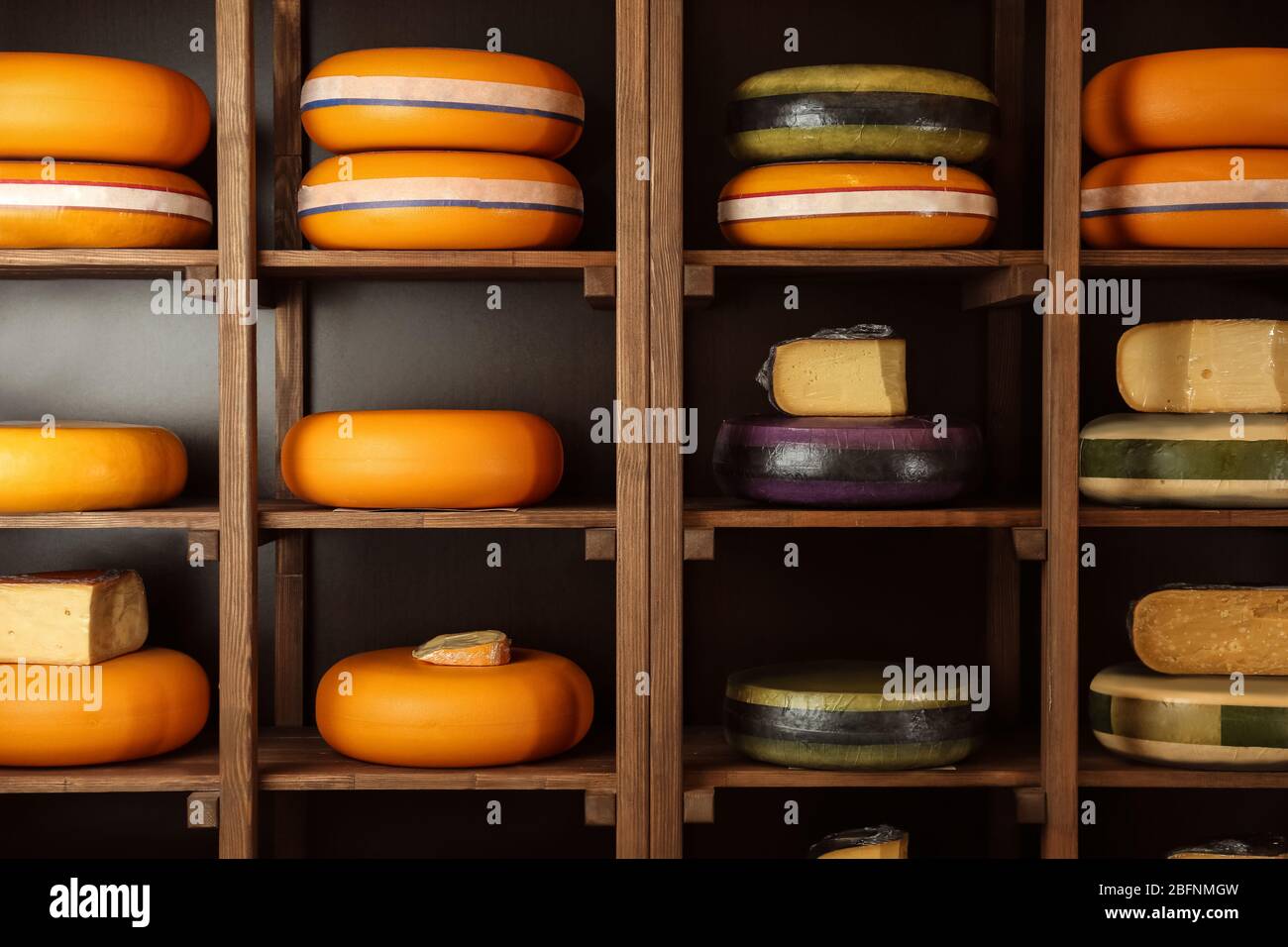 Wooden stand with different kinds of delicious cheese in shop Stock ...
