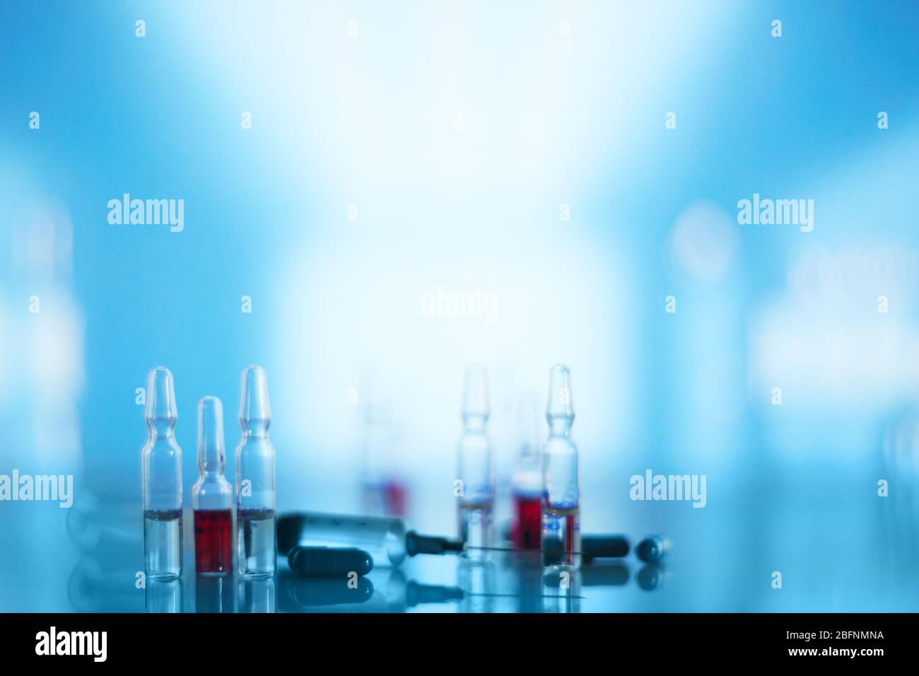 Medical syringe and vials on table in hospital Stock Photo - Alamy