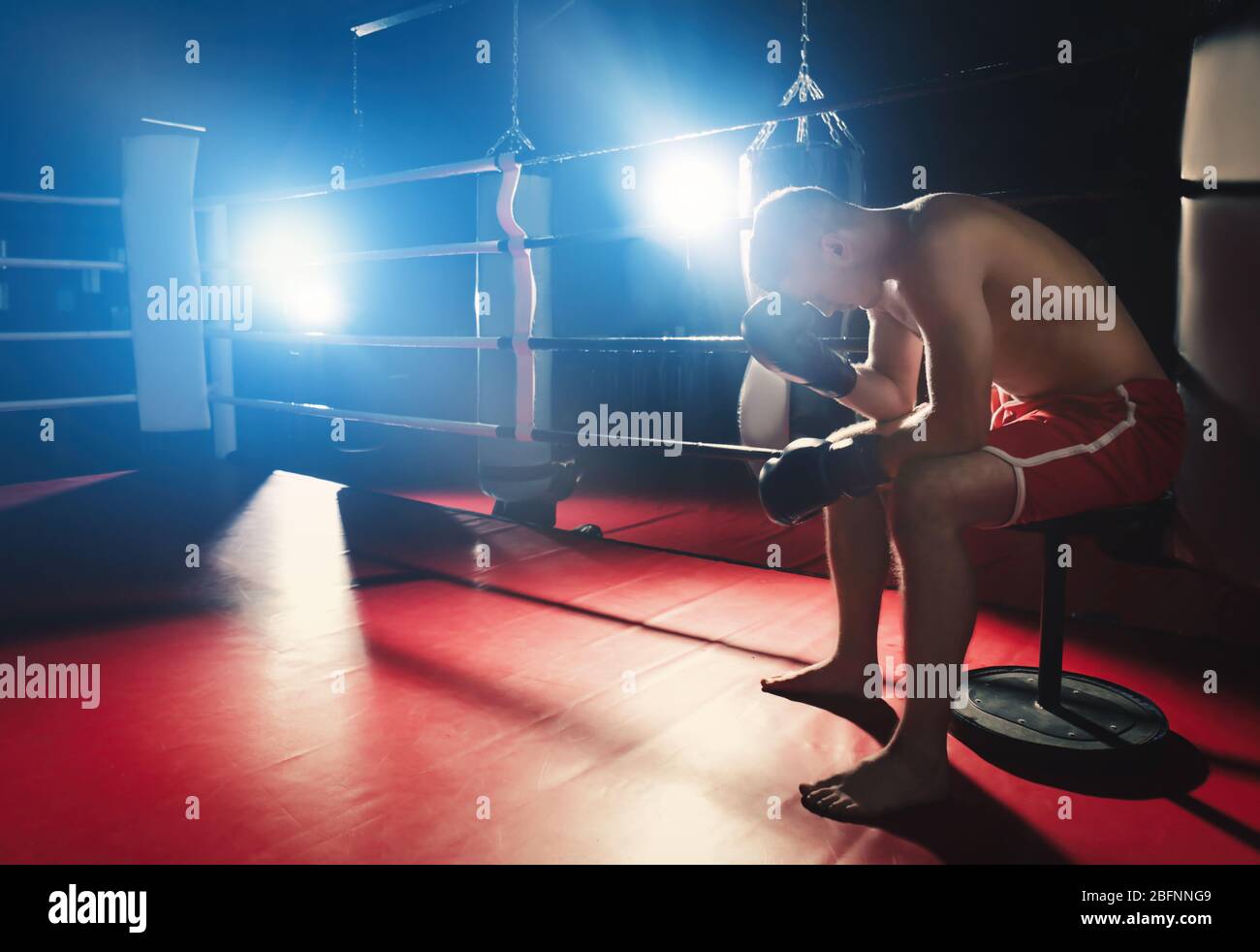 Professional boxer having break during training in ring Stock Photo - Alamy