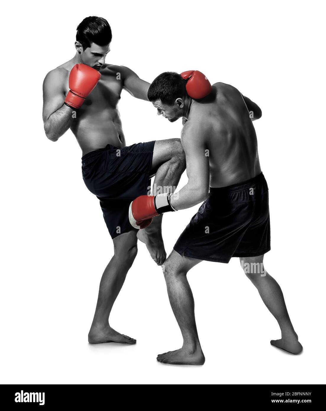 Young kickboxers fighting on white background Stock Photo - Alamy