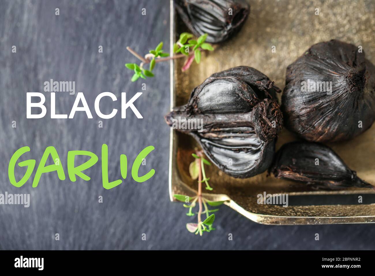 Tray with black garlic (Allium sativum) on table Stock Photo - Alamy