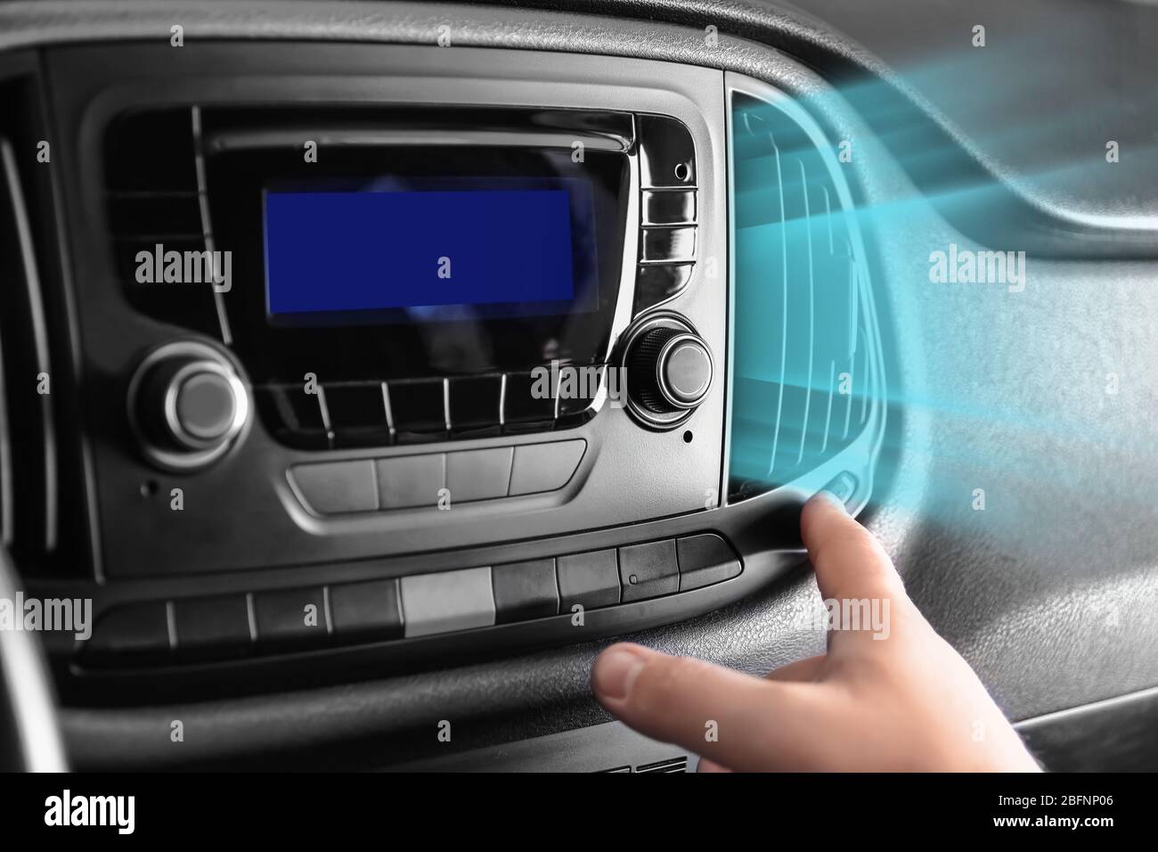 Driver turning on air conditioner in car Stock Photo - Alamy