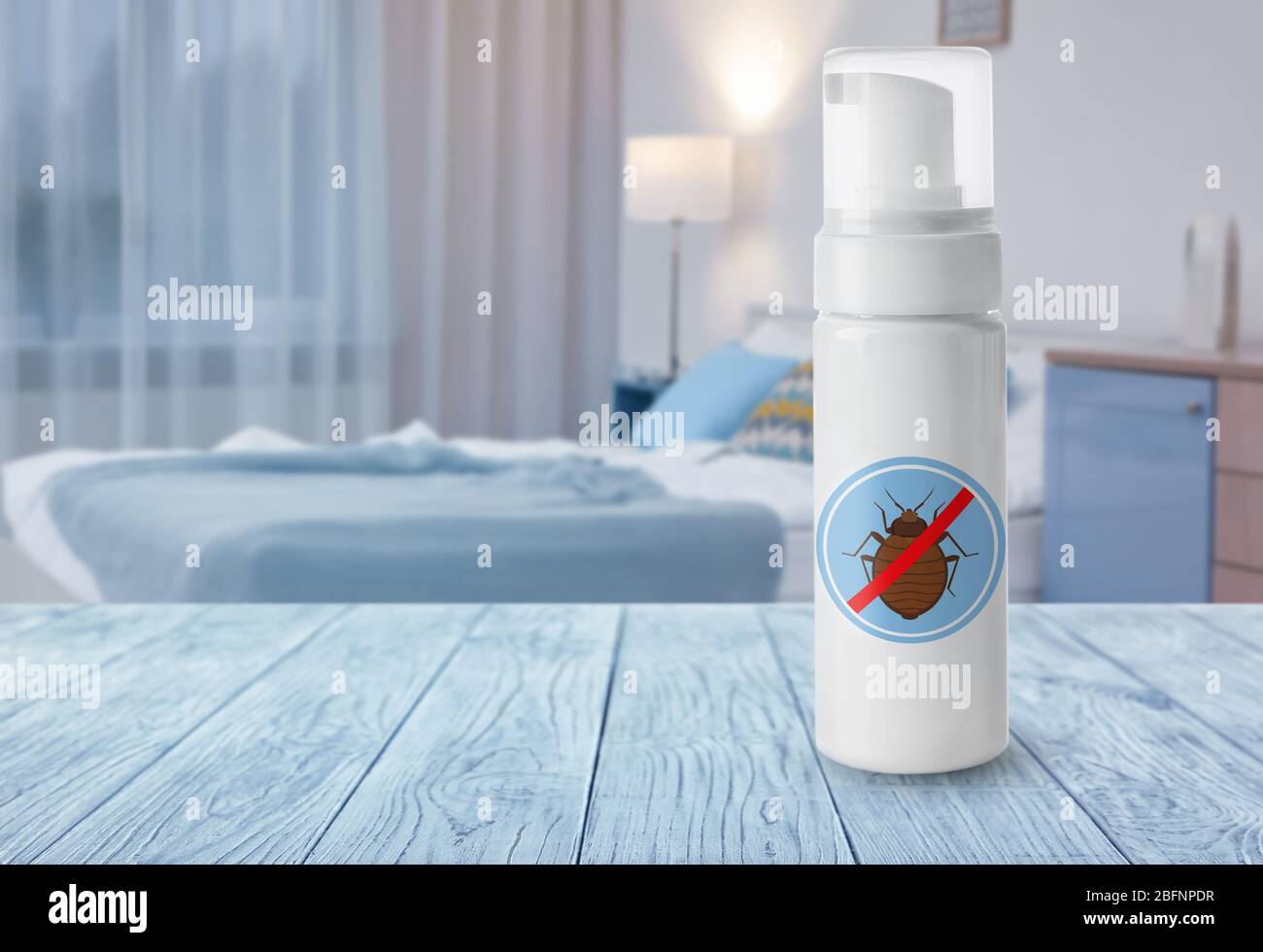 Bottle of anti bed bug detergent on table in bedroom Stock Photo - Alamy