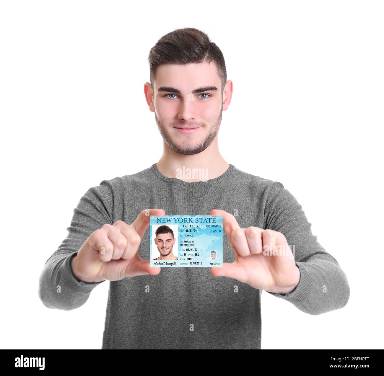 Man with driving license on white background Stock Photo - Alamy