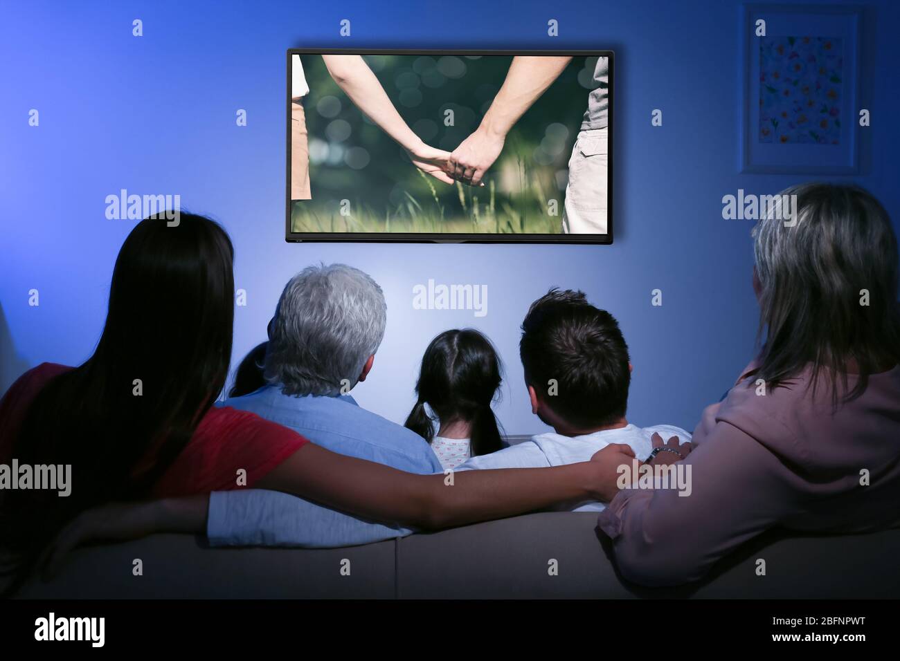 Family watching television at home. Leisure and entertainment concept ...