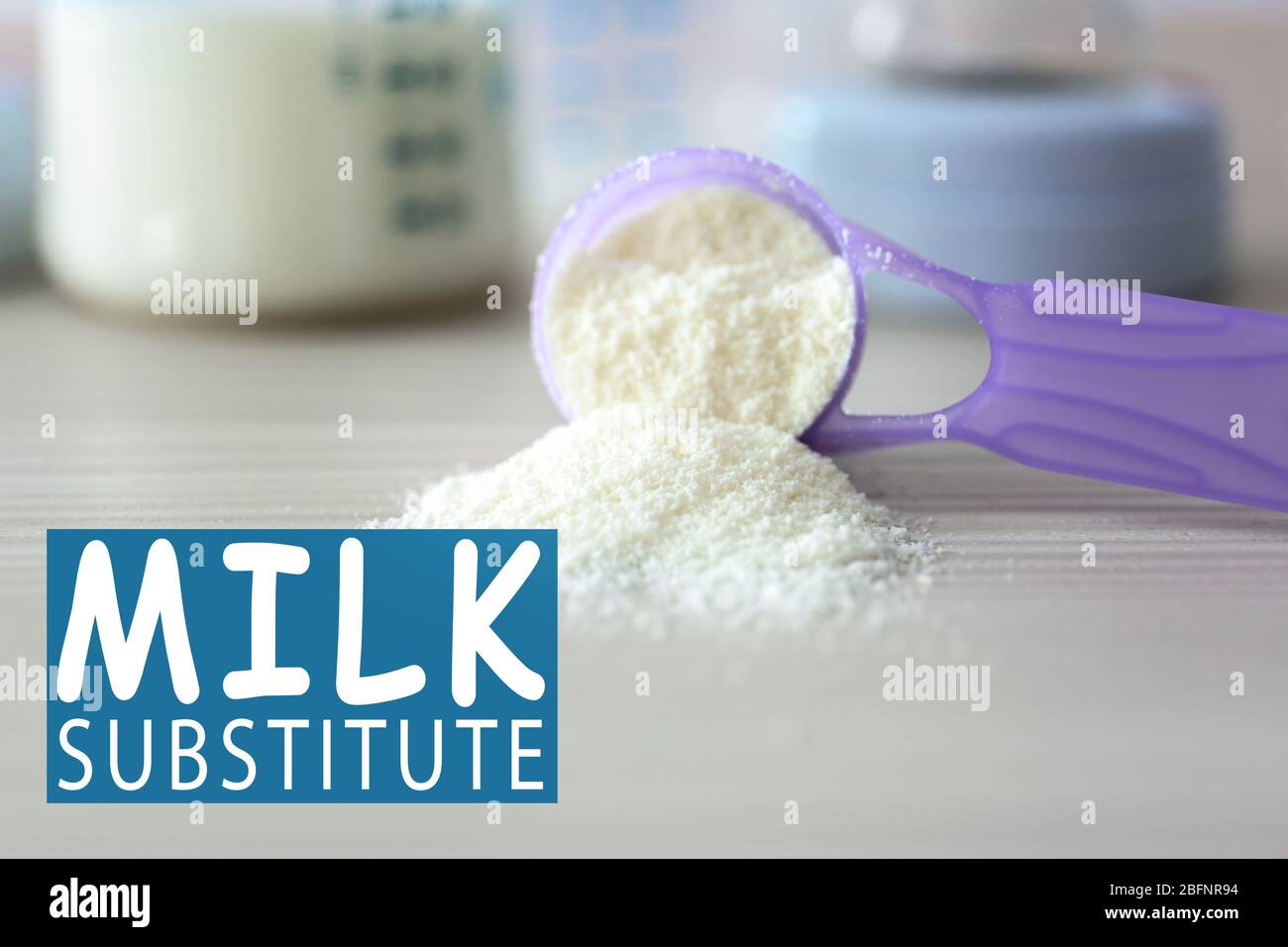 Food substitute concept. Powdered baby milk formula in scoop on table ...