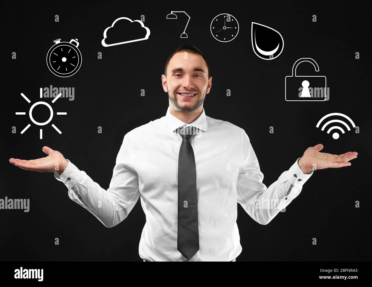 Business and time management concept. Young man on black background ...