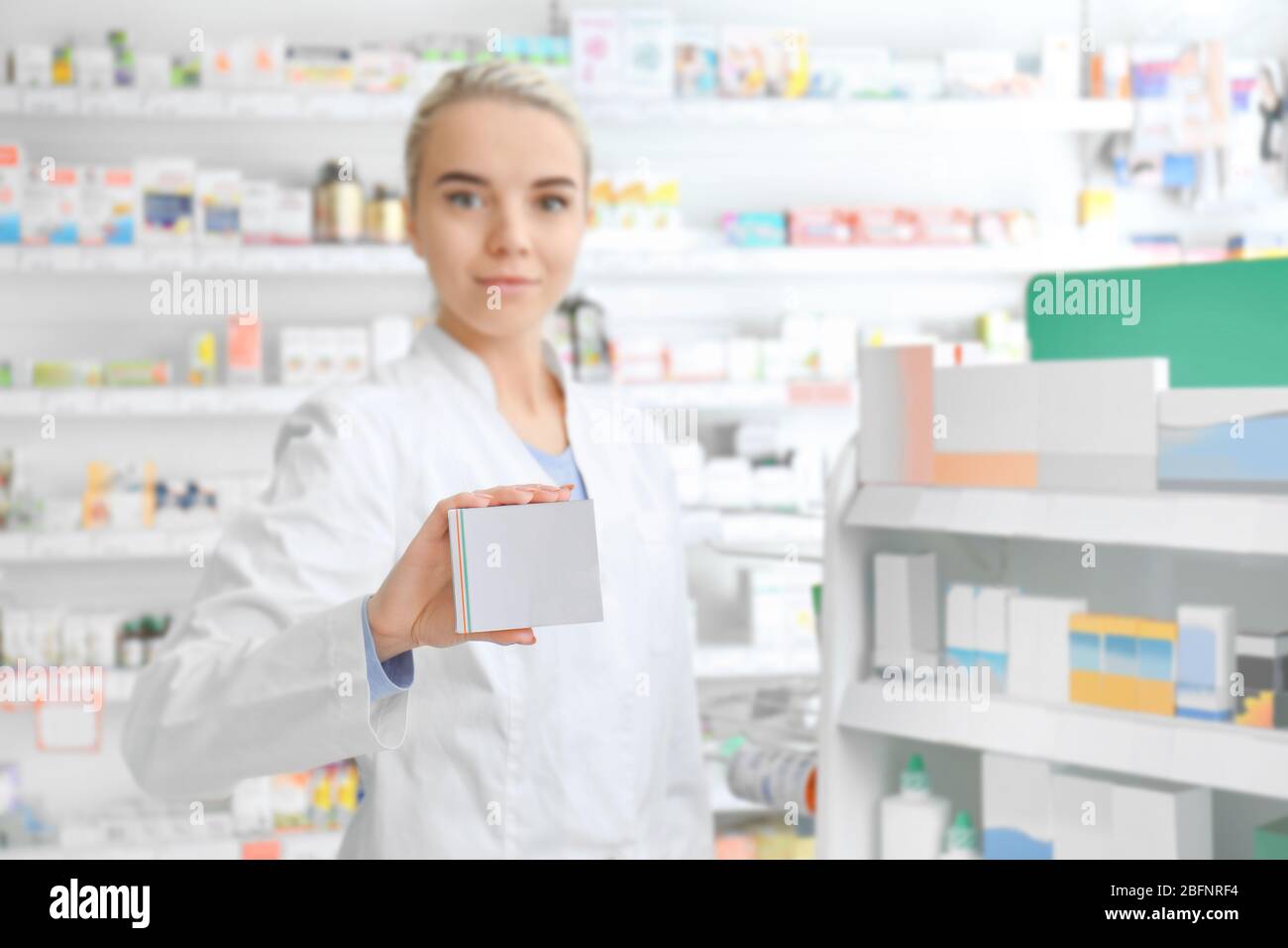 Female shop assistant with cardboard package at work Stock Photo - Alamy