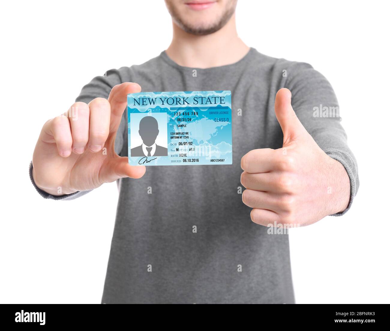 Man with driving license on white background Stock Photo - Alamy