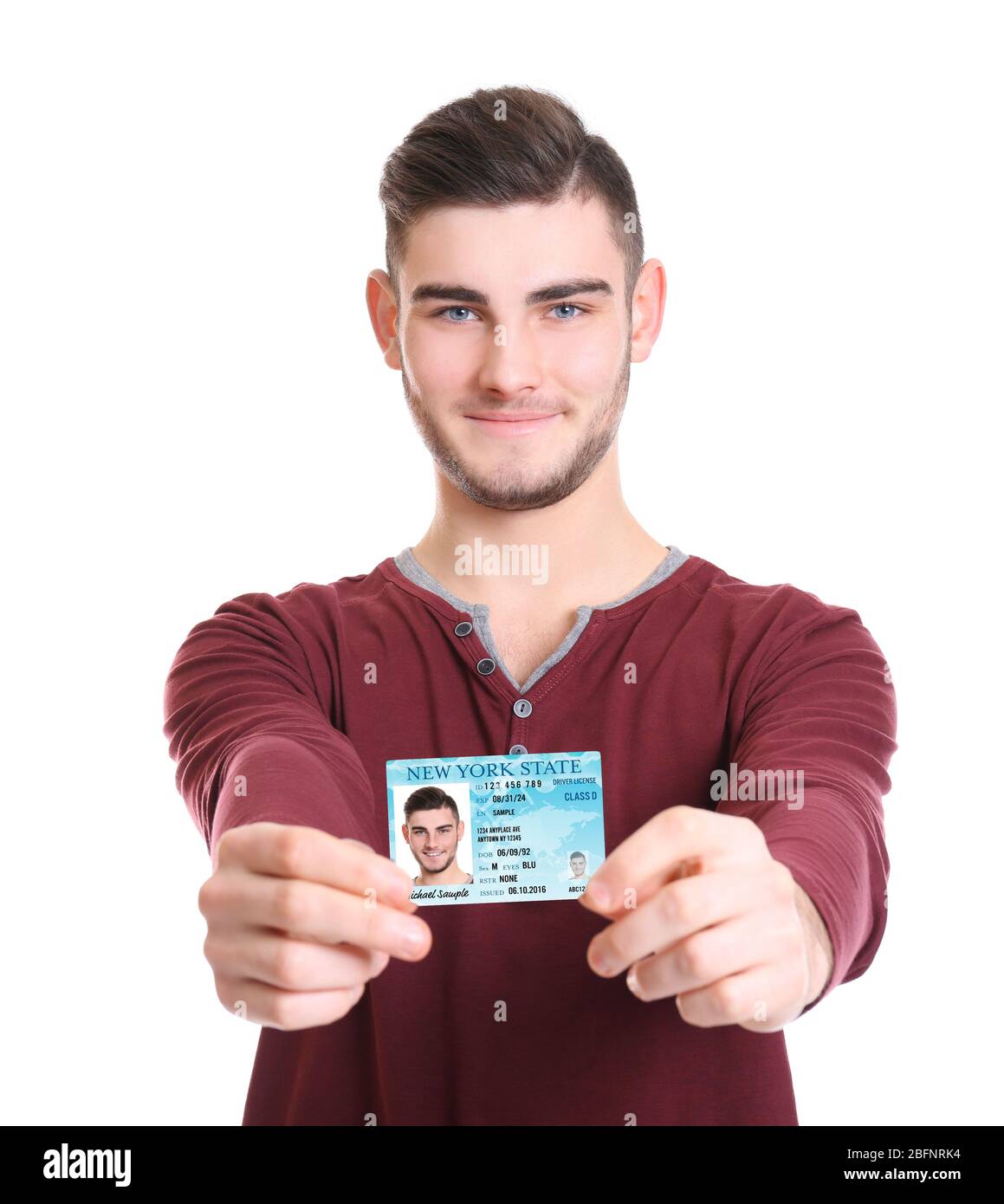 Man with driving license on white background Stock Photo - Alamy