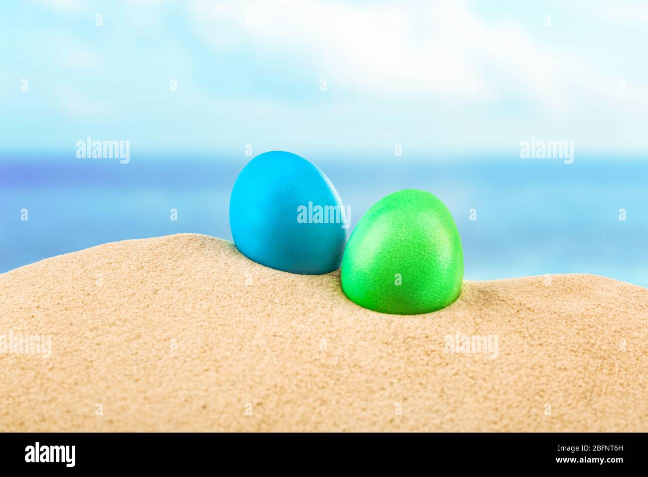Easter eggs on sand at sea shore Stock Photo - Alamy