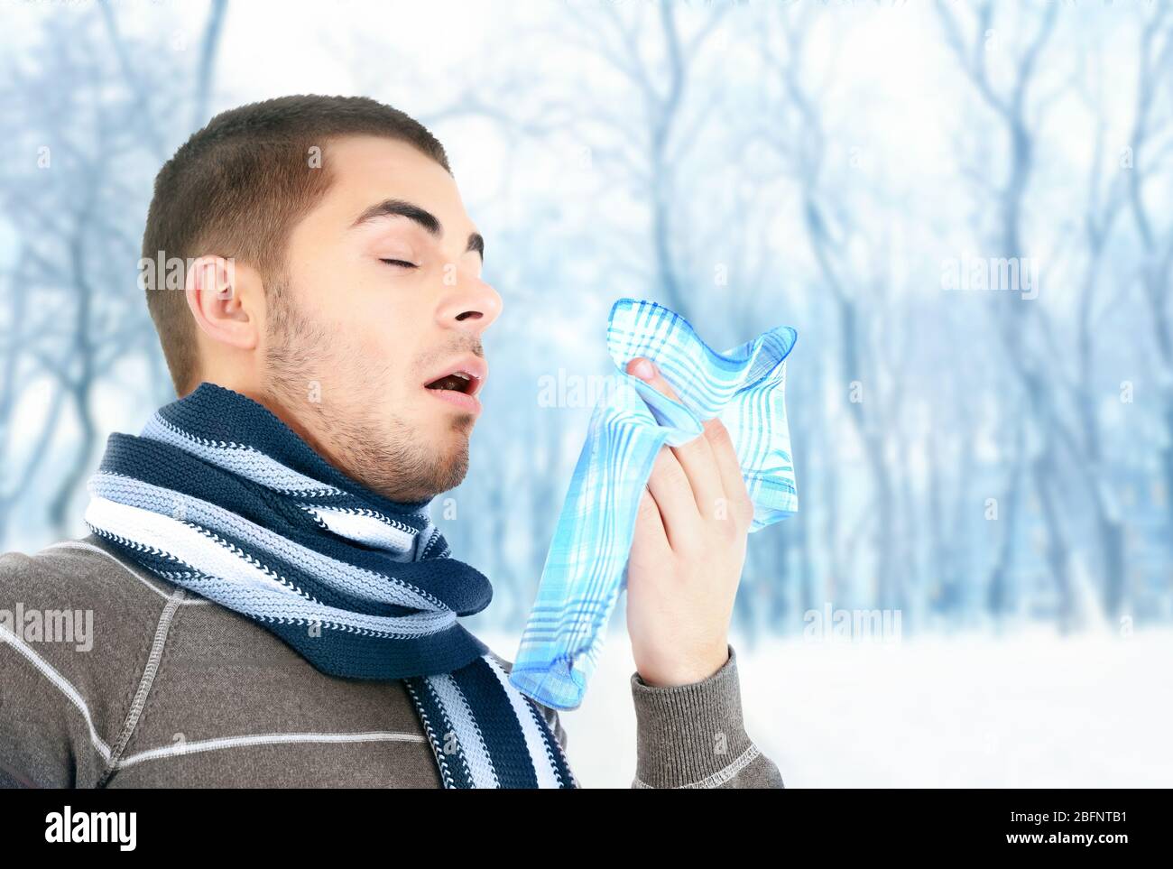 Sick man with handkerchief in winter, outdoor Stock Photo - Alamy