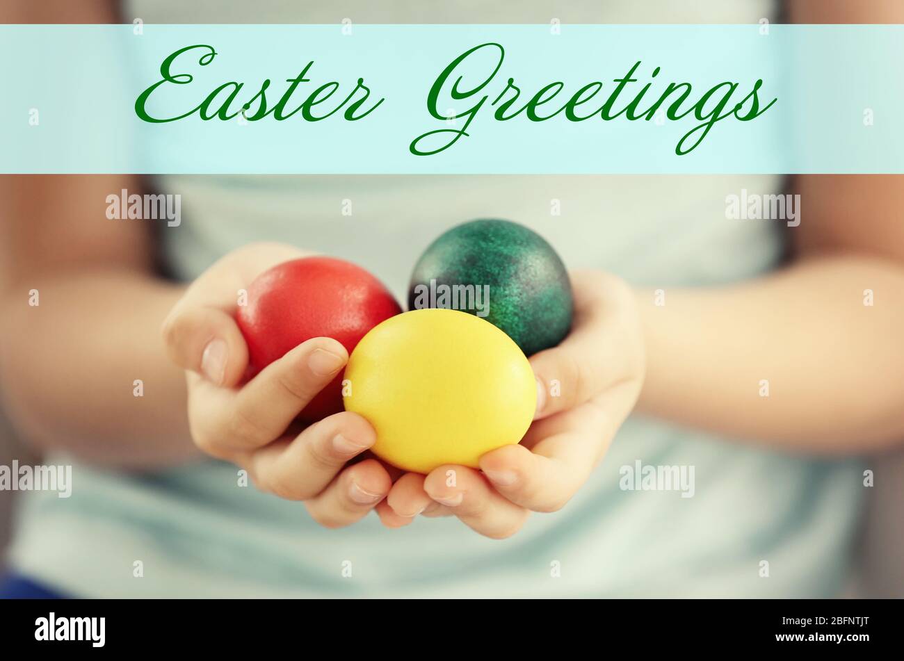 Greeting card design. Child holding Easter eggs in hands Stock Photo ...