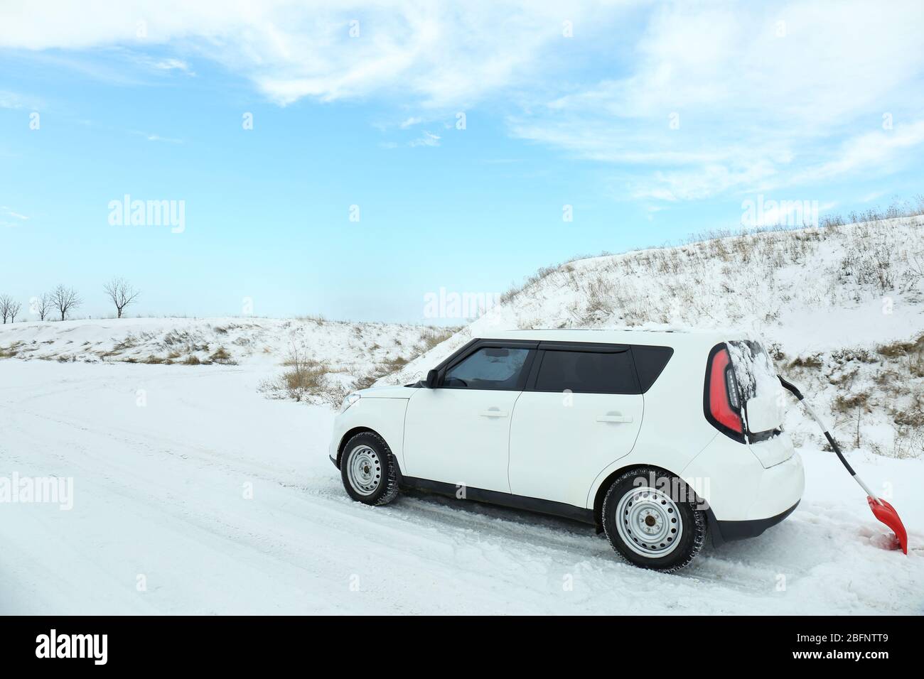 Car stuck in snowdrift on winter road Stock Photo - Alamy