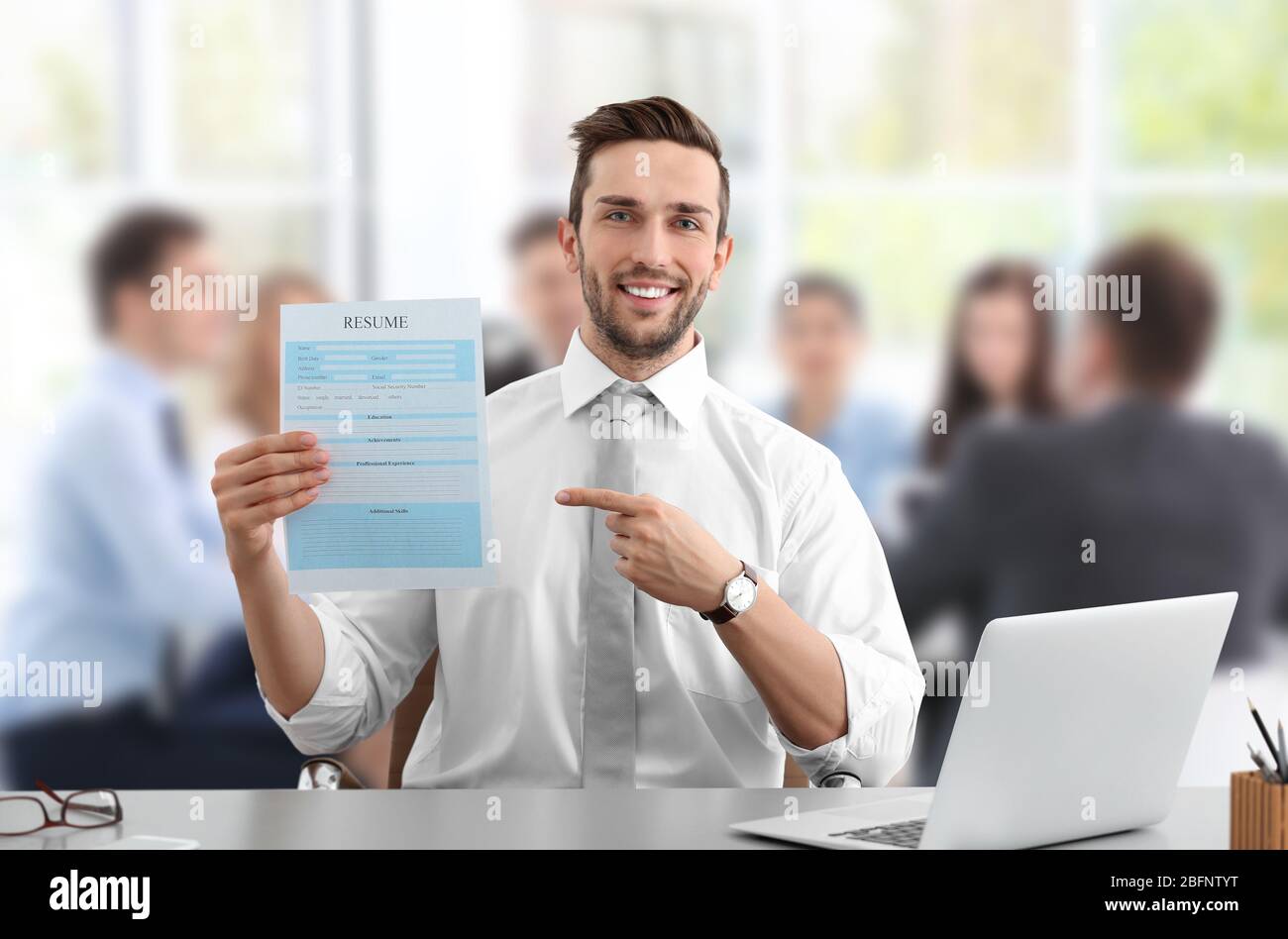 HR manager proposing fill in resume Stock Photo - Alamy