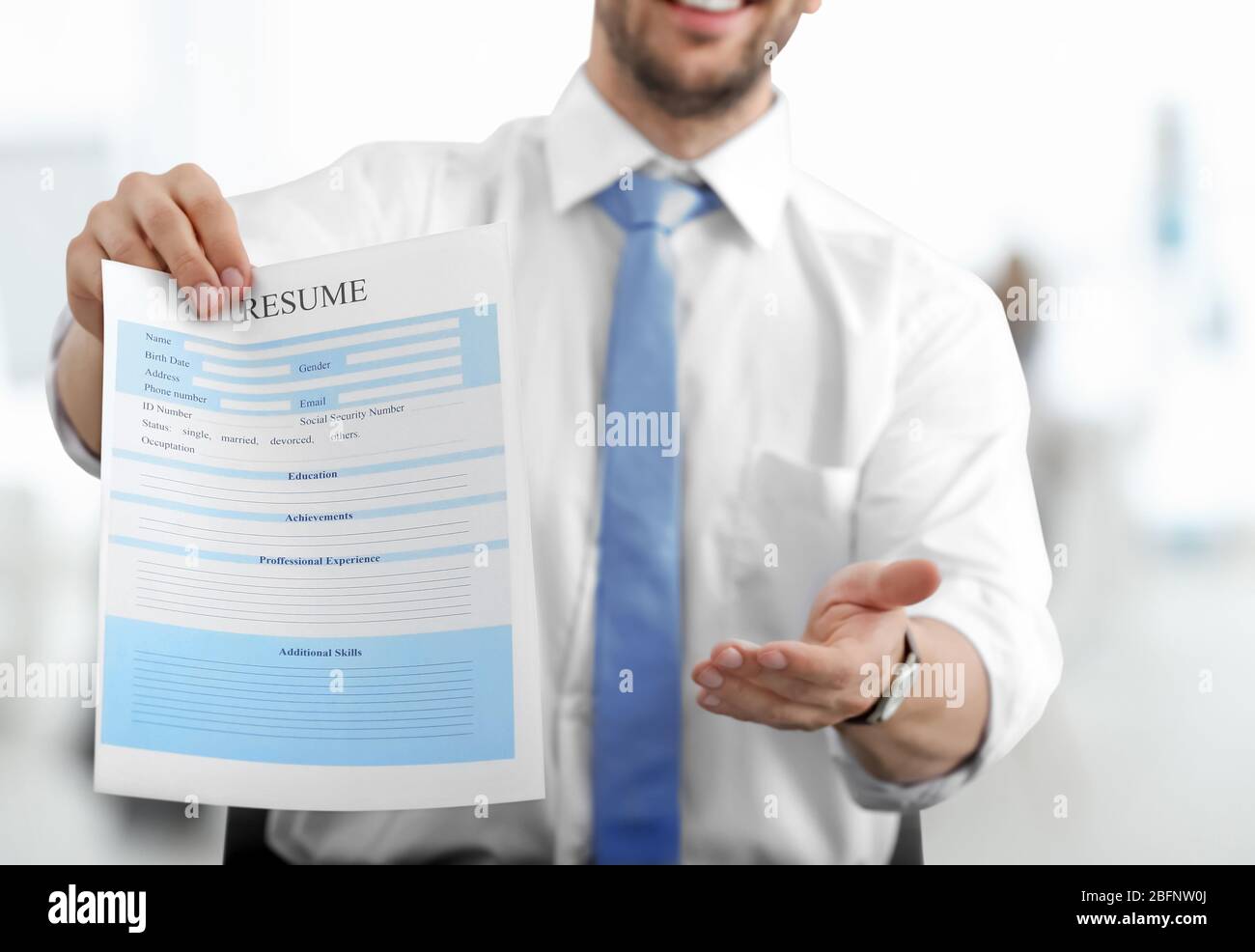 HR manager proposing fill in resume Stock Photo - Alamy