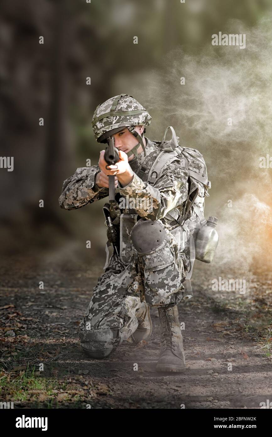 Soldier taking aim from rifle on battlefield Stock Photo - Alamy