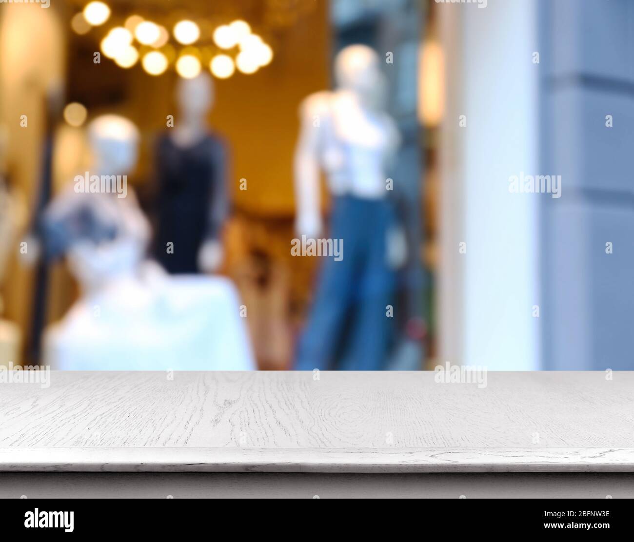 Wooden table on blurred showcase background Stock Photo - Alamy
