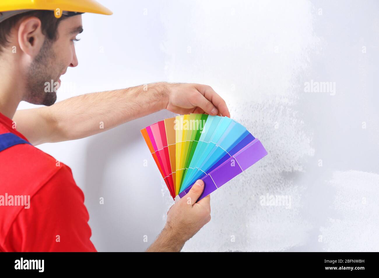 Worker holding palette for choosing color of wall Stock Photo - Alamy
