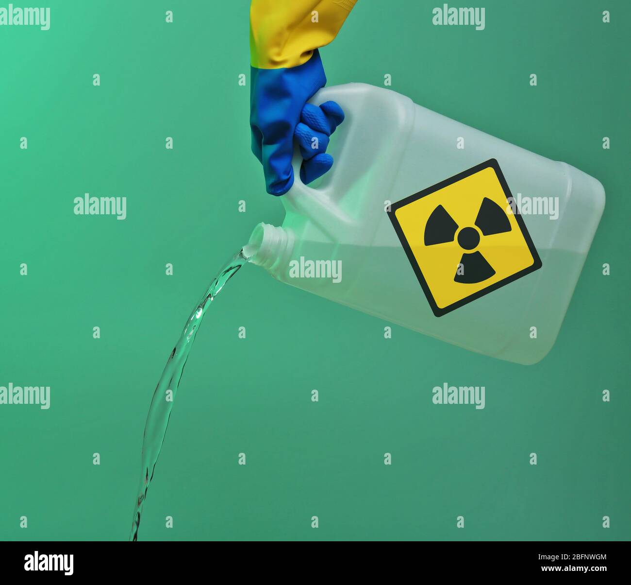 Environmental pollution concept. Hand pouring toxic water from can ...