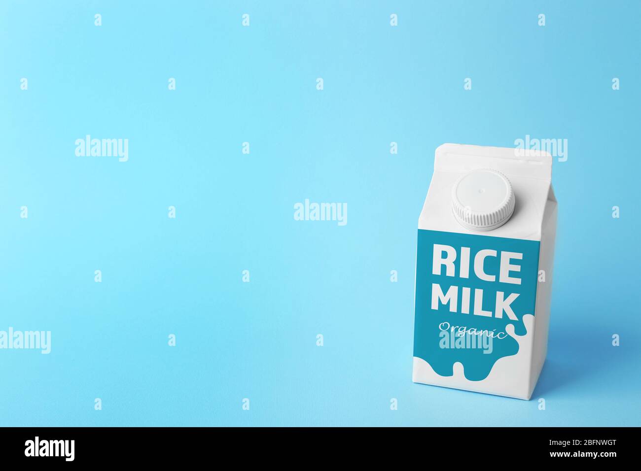 Pack of rice milk on blue background Stock Photo - Alamy