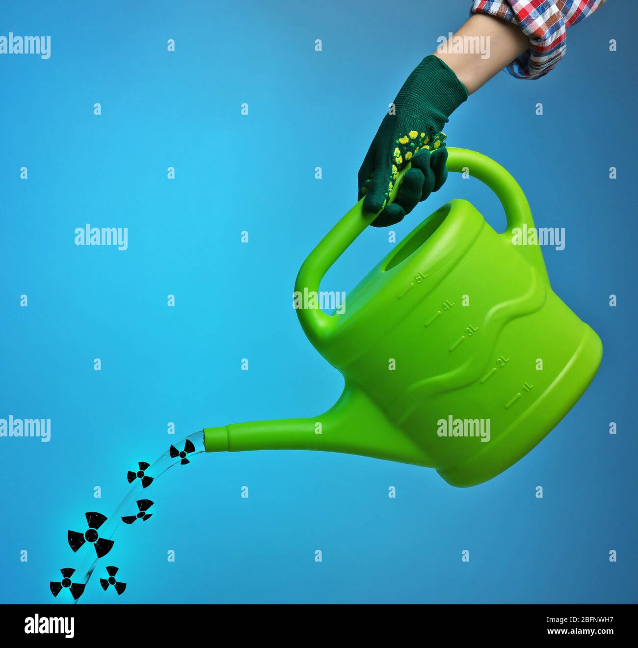 Environmental pollution concept. Hand pouring toxic water from can ...