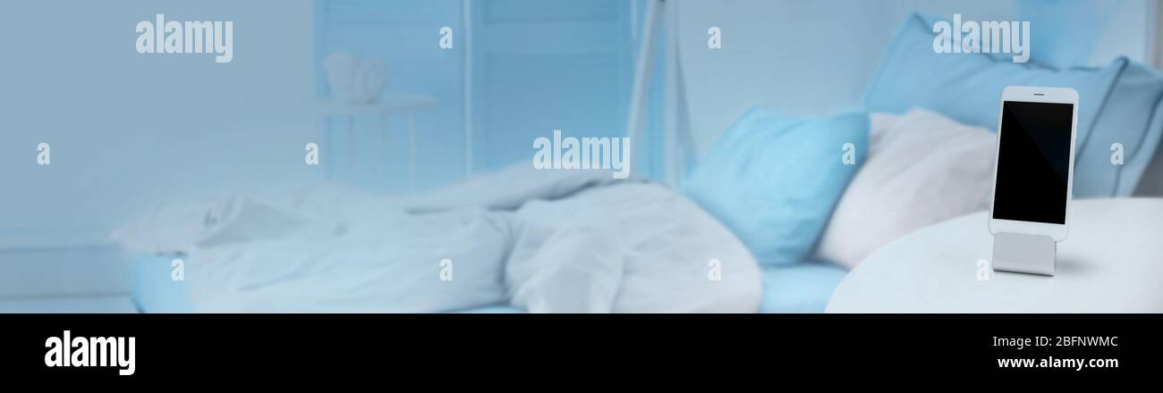 Smartphone on table in bedroom Stock Photo - Alamy