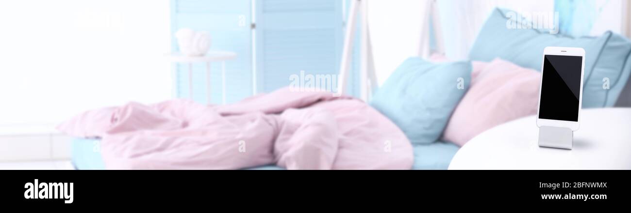 Smartphone on table in bedroom Stock Photo - Alamy