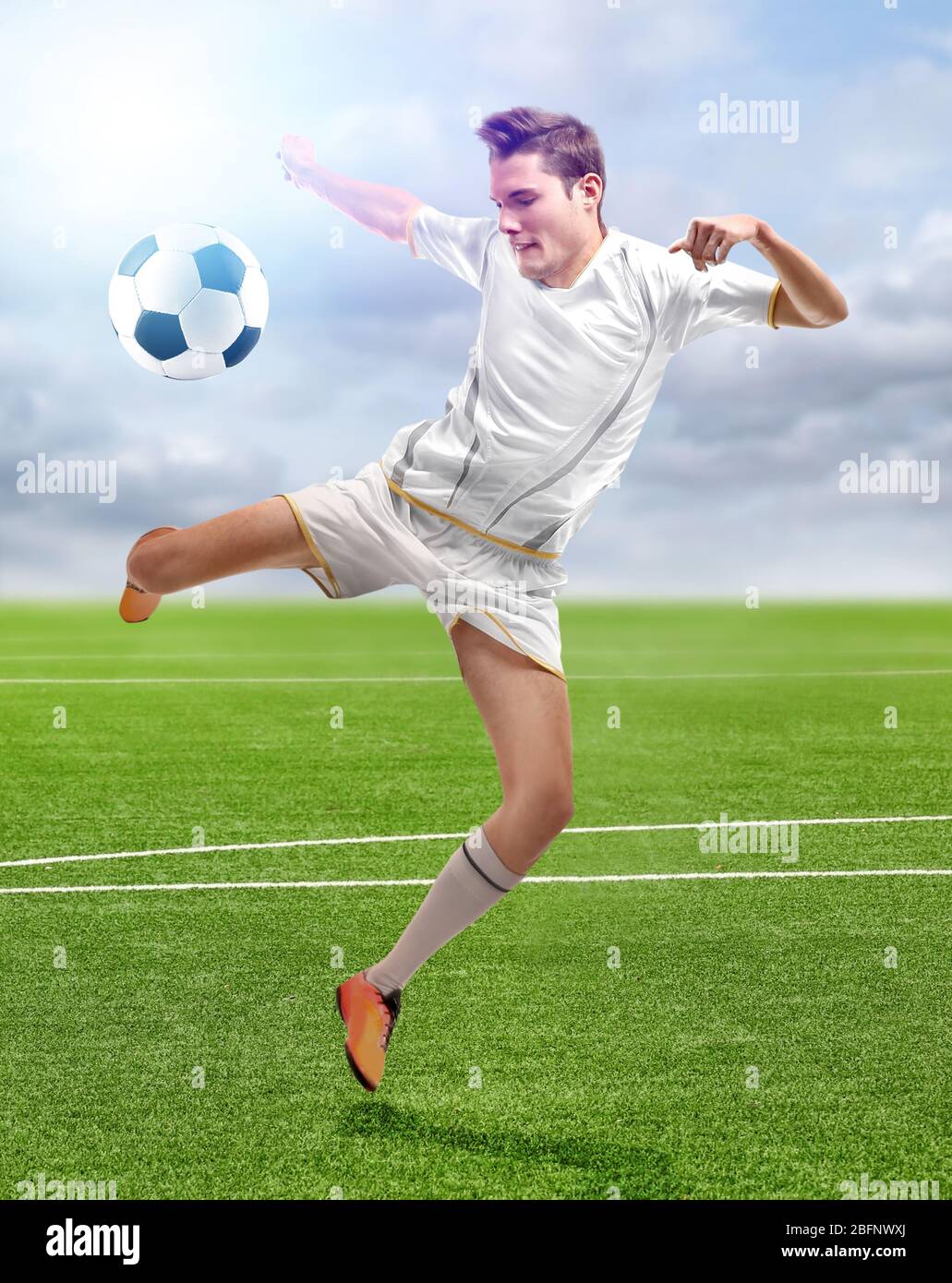 Professional sportsman playing football at stadium Stock Photo - Alamy
