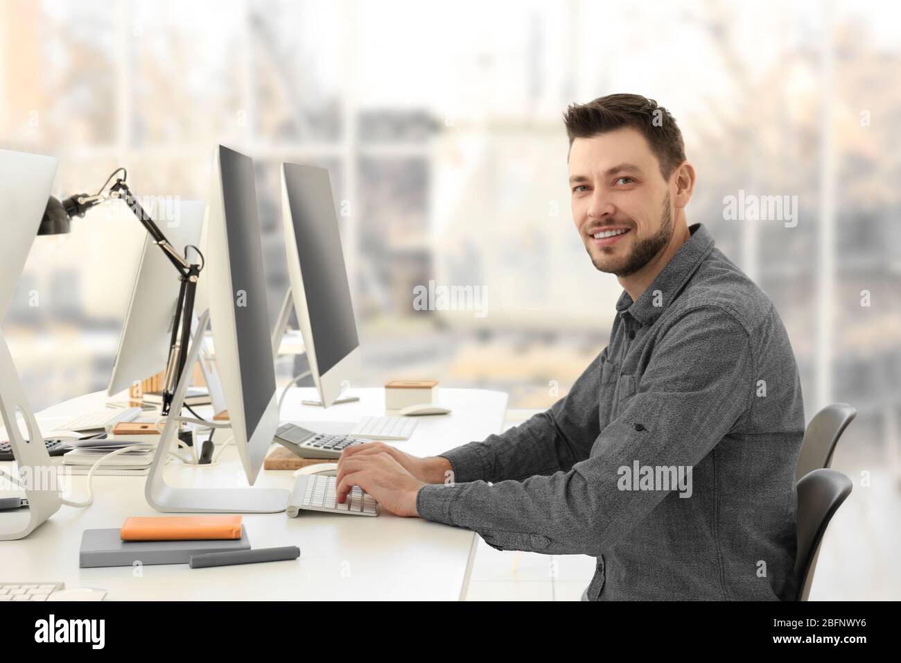 Programmer working in office Stock Photo - Alamy