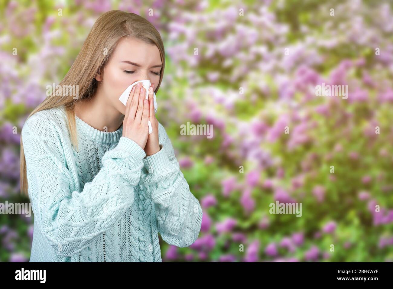 Seasonal allergy. Young woman with tissue outdoor Stock Photo - Alamy