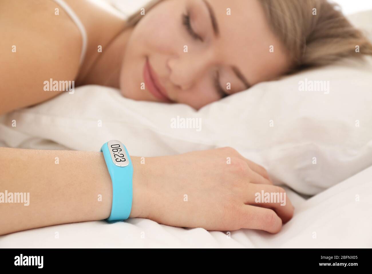 Young woman with sleep tracker resting in bed at home Stock Photo - Alamy