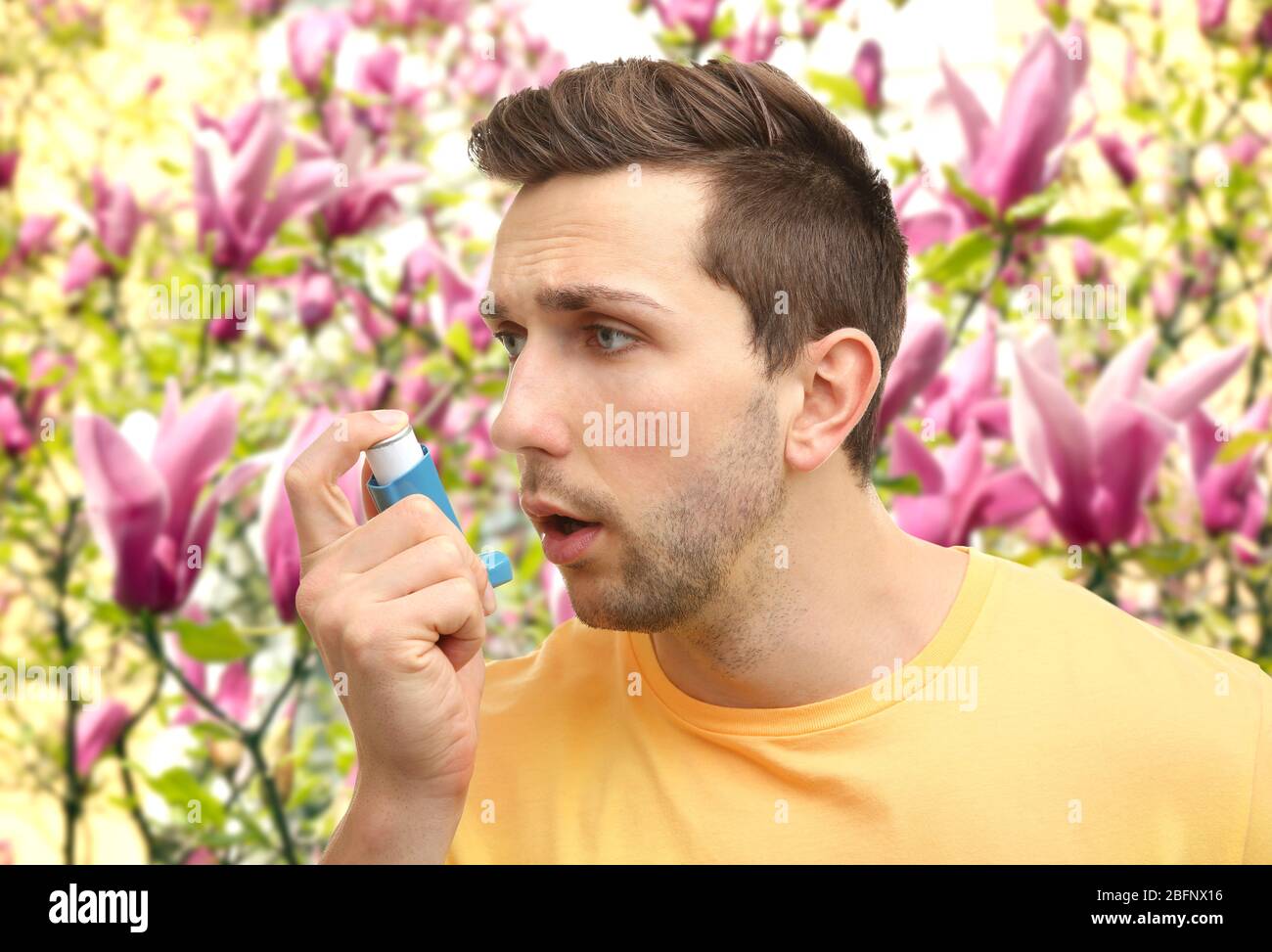 Young man using asthma inhaler outdoor Stock Photo - Alamy