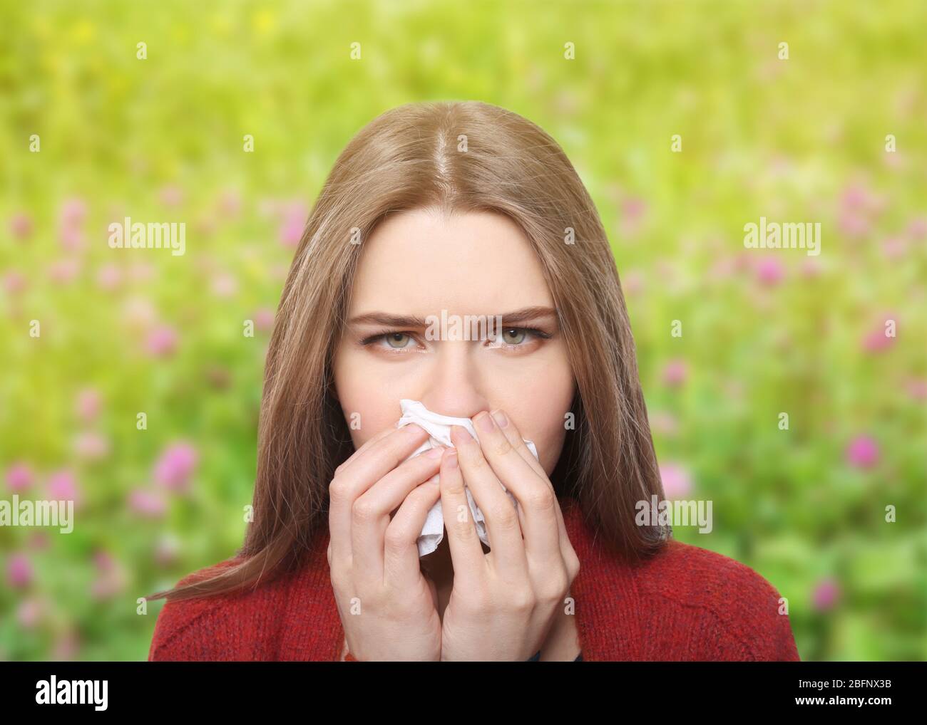 Seasonal allergy. Young woman with tissue outdoor Stock Photo - Alamy