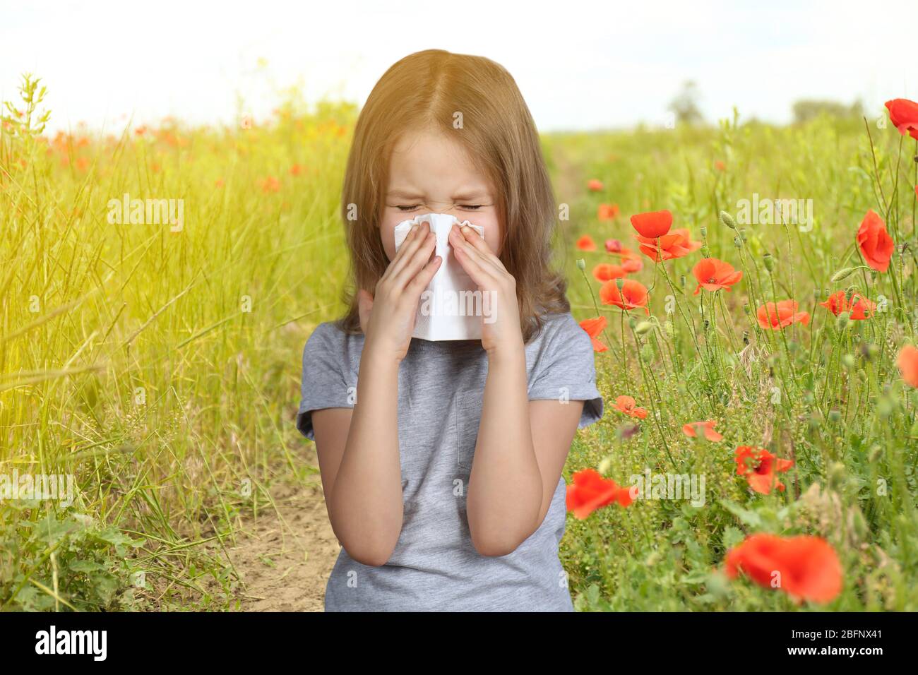 Seasonal allergy. Little girl with tissue outdoor Stock Photo - Alamy