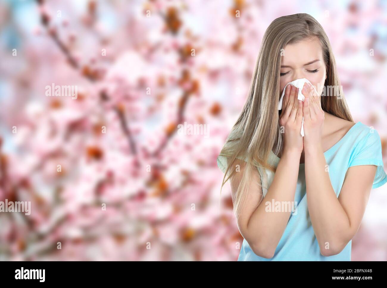 Seasonal allergy. Young woman with tissue outdoor Stock Photo - Alamy