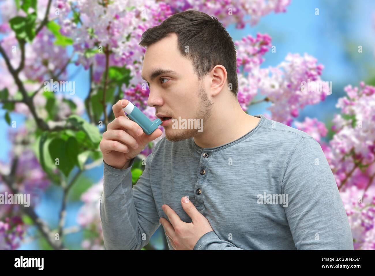 Young man using asthma inhaler outdoor Stock Photo - Alamy