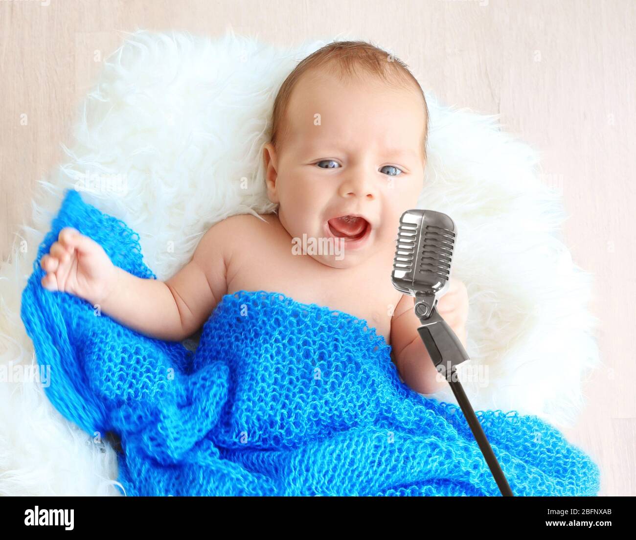 Cute baby with microphone at home Stock Photo - Alamy