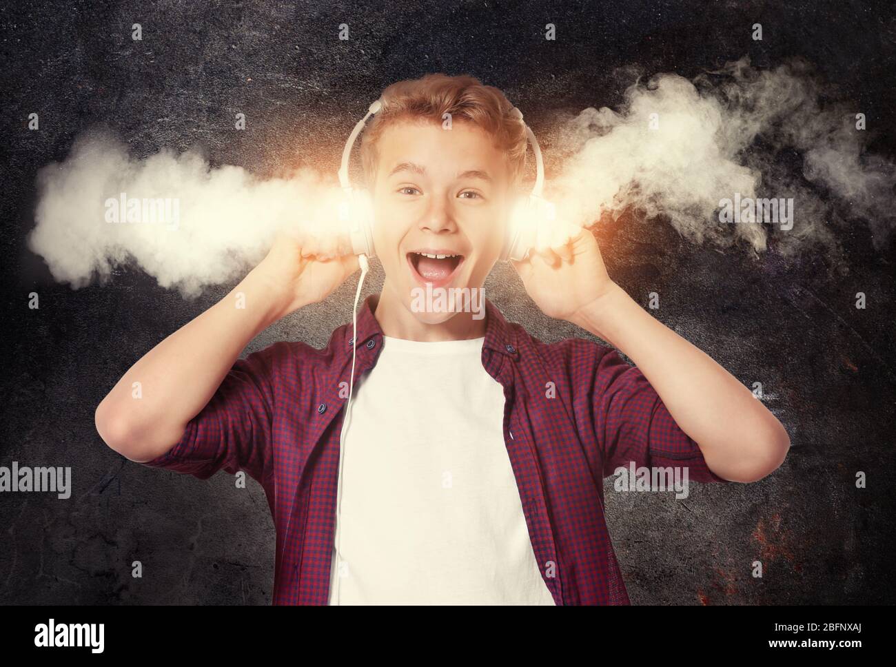 Teenage boy listening to music and smoke coming out of headphones on ...