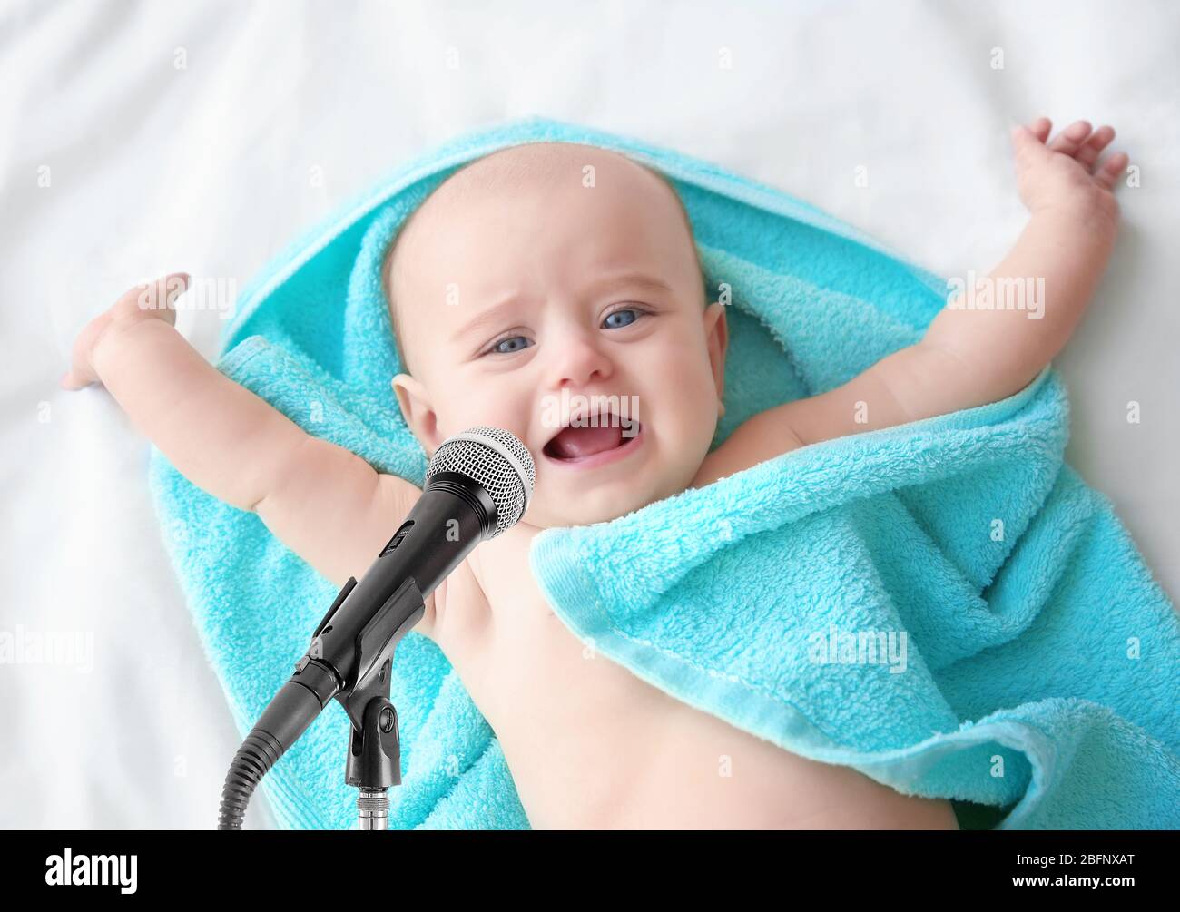 Cute baby with microphone at home Stock Photo - Alamy
