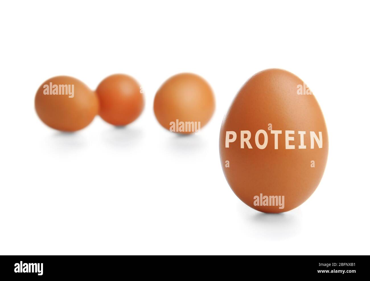 Protein concept. Raw egg on white background Stock Photo - Alamy