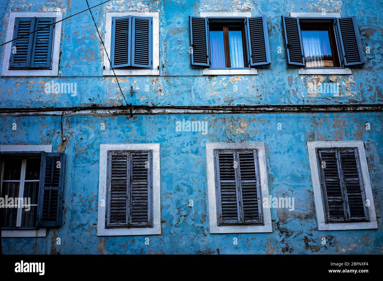 Old blue building with damaged blue facade Stock Photo - Alamy