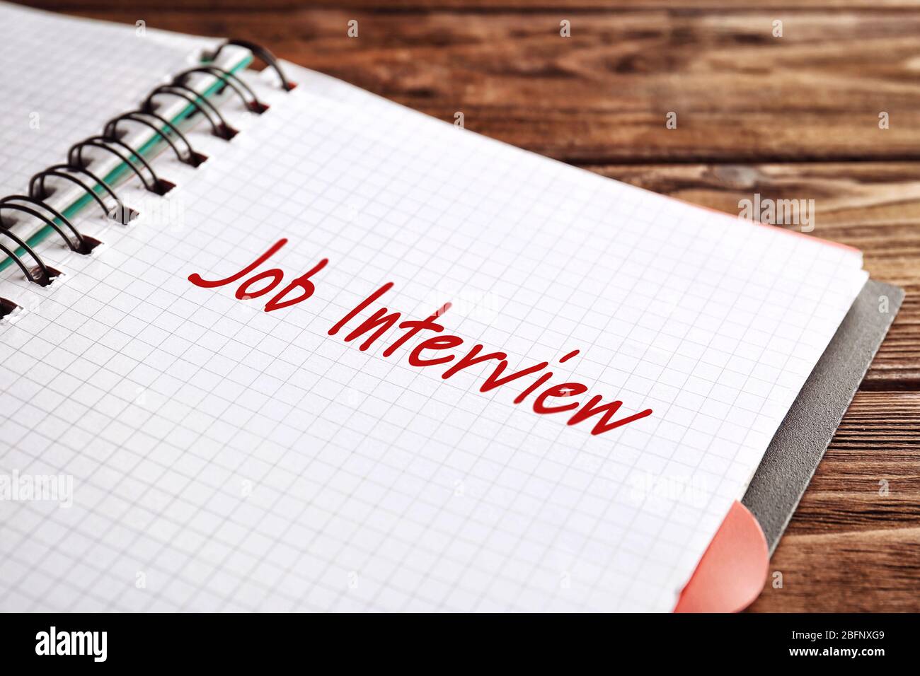 Text JOB INTERVIEW written in notebook on wooden background. Human ...