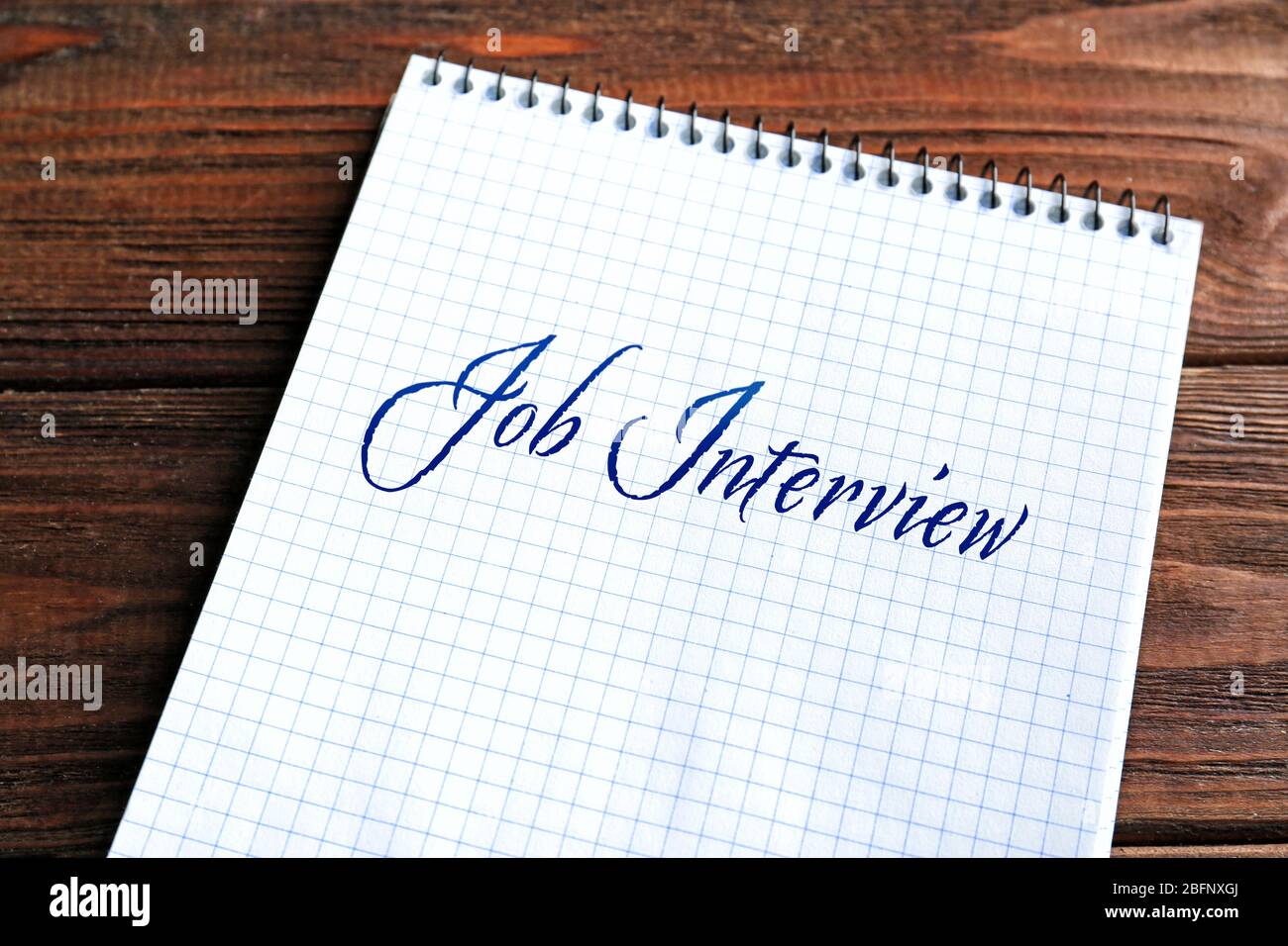 Text JOB INTERVIEW written in notebook on wooden background. Human ...