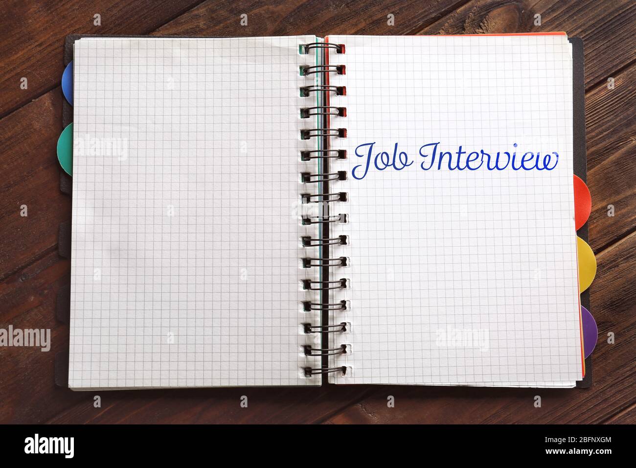 Text JOB INTERVIEW written in notebook on wooden background. Human ...