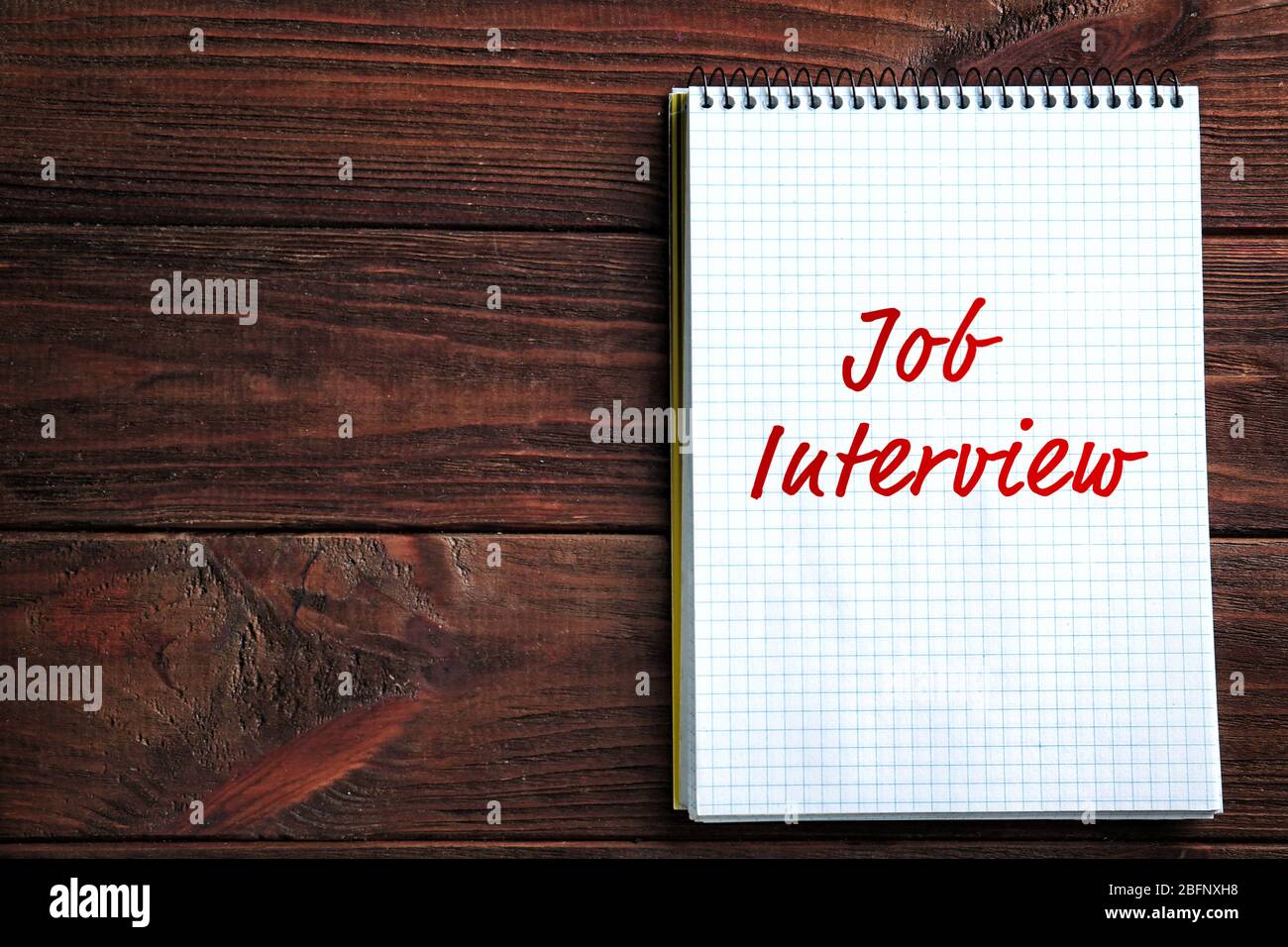 Text JOB INTERVIEW written in notebook on wooden background. Human ...
