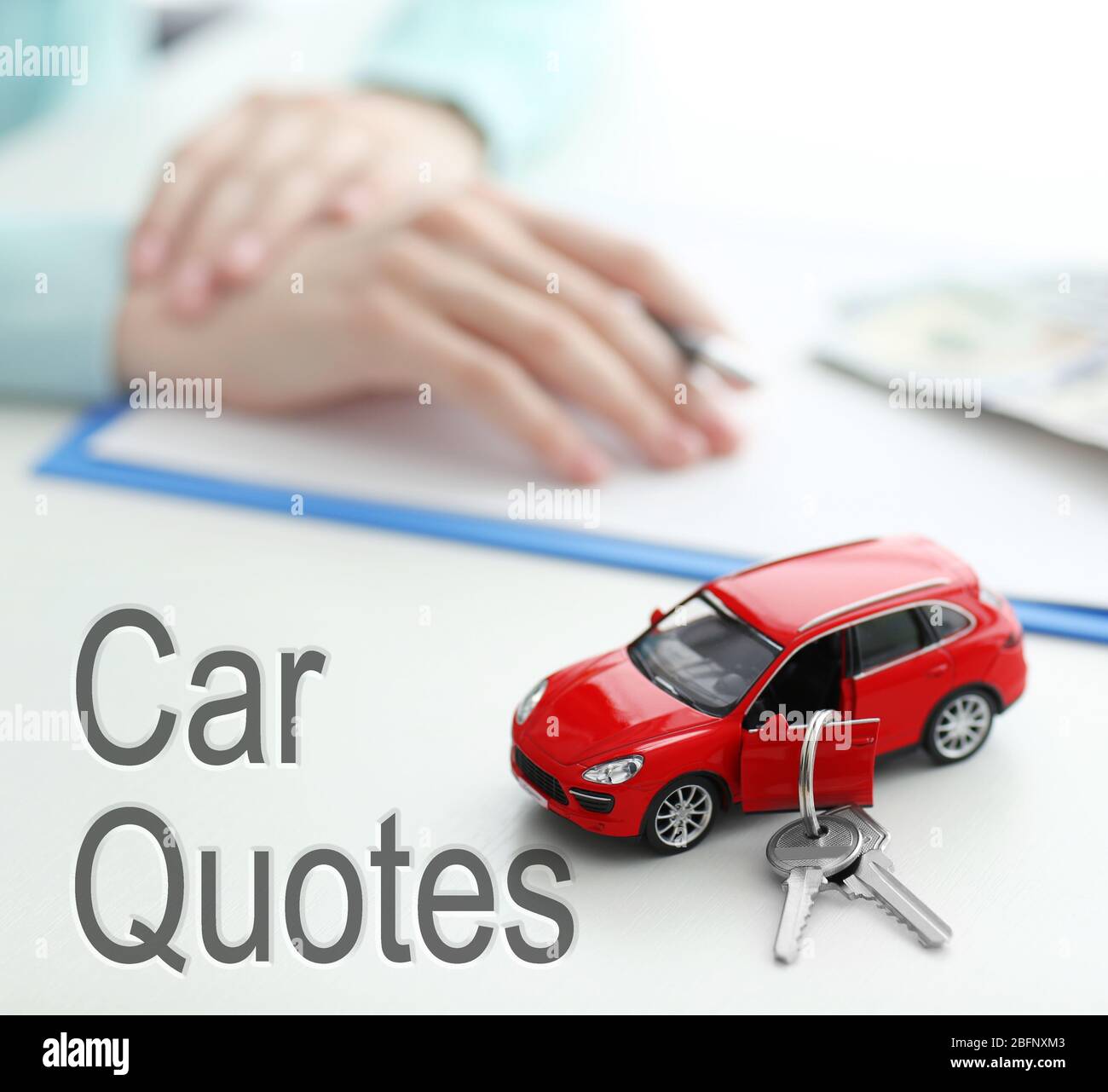 Car quotes concept. Toy automobile, keys and woman on background Stock ...