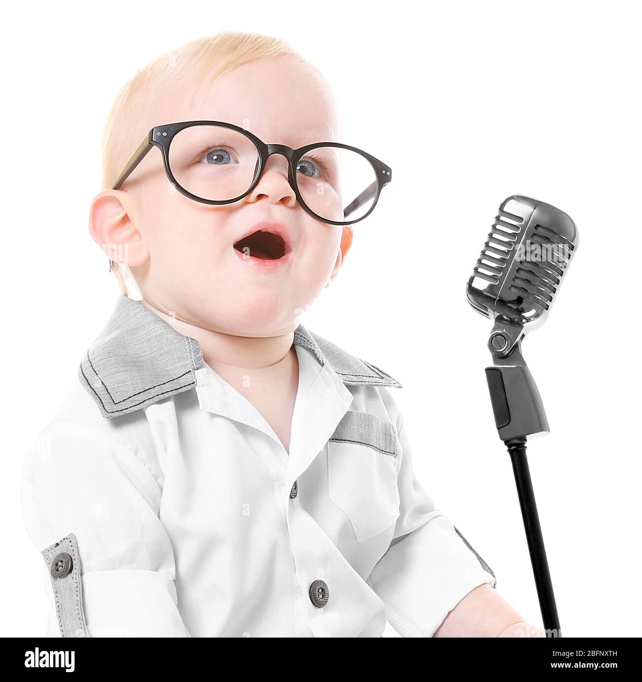 Cute baby with microphone on white background Stock Photo - Alamy