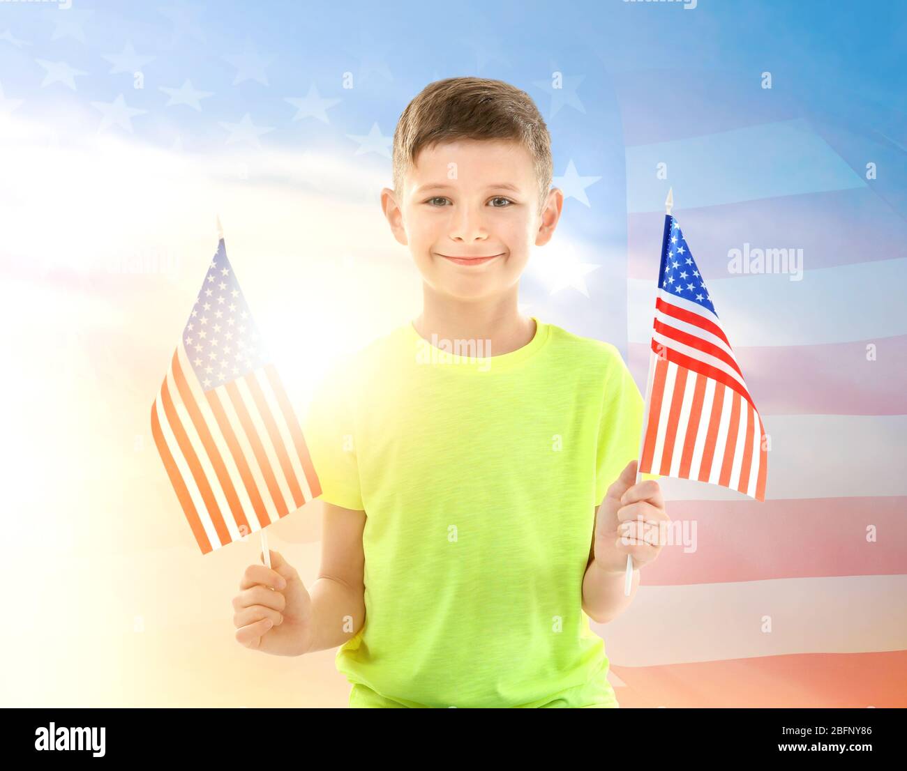 Little boy with USA flags on sky background Stock Photo - Alamy