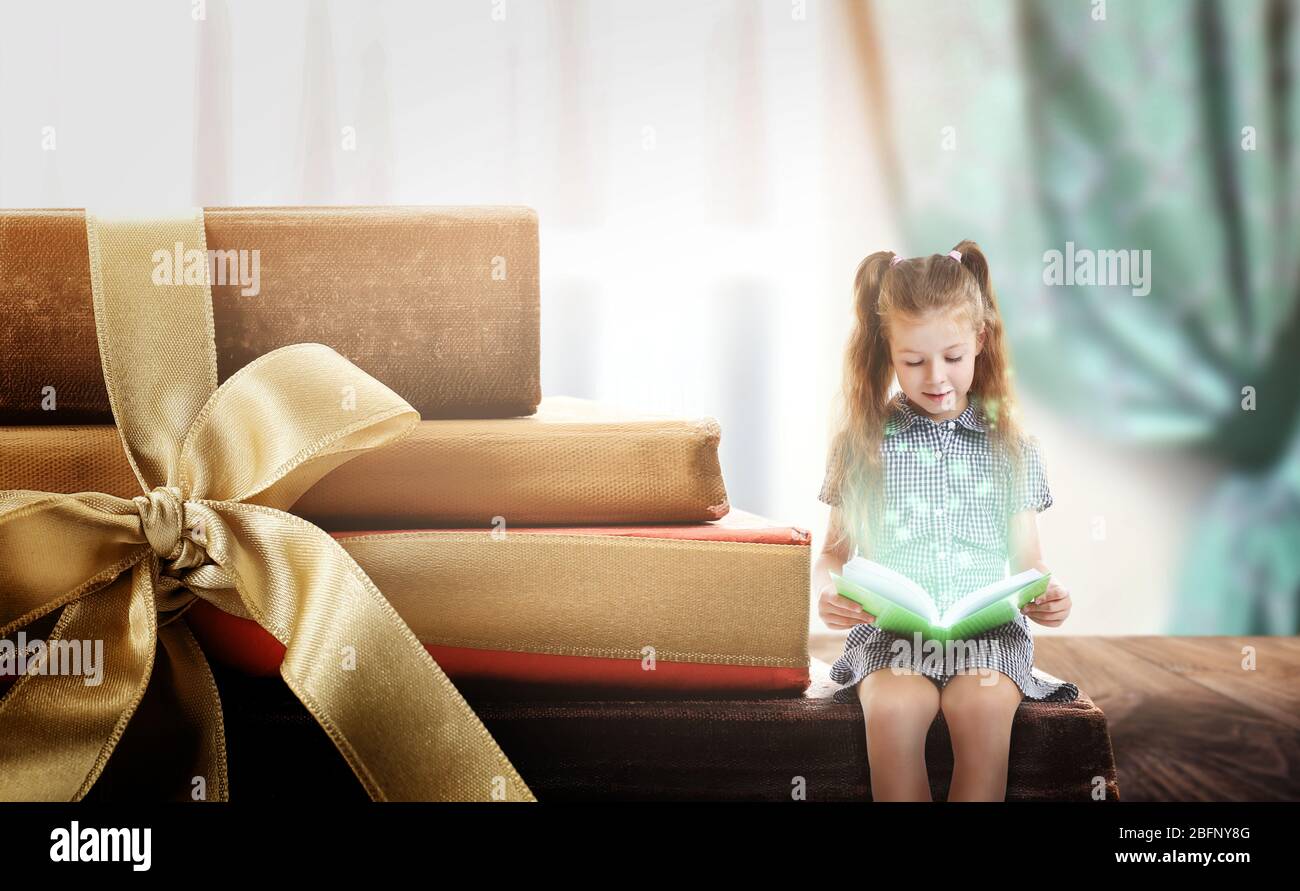 Adventure story and fairy tale. Tiny girl with books and magic glowing ...